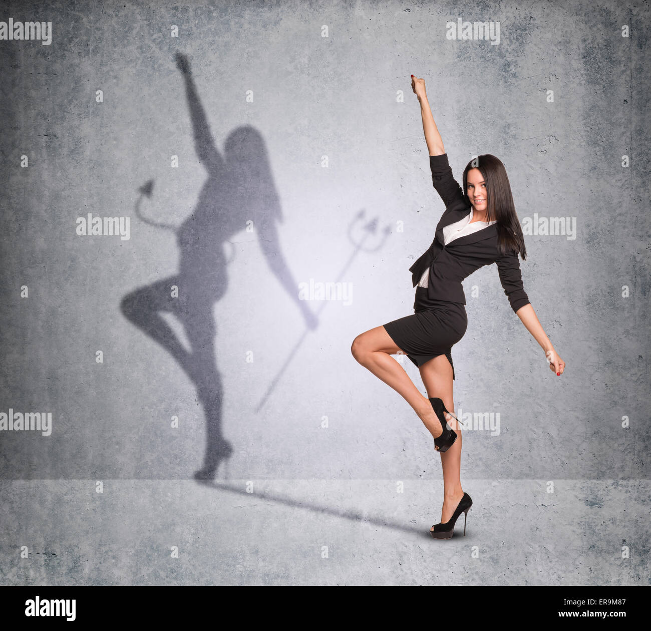 Businesswoman with shadow showing devil side Stock Photo - Alamy