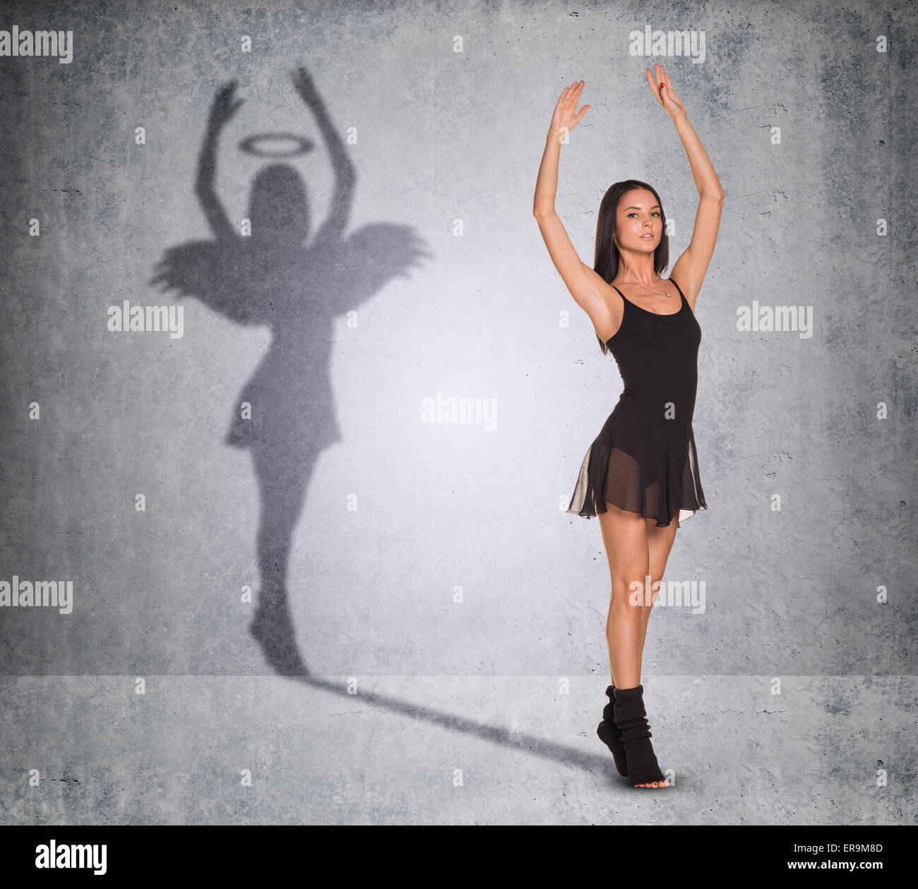 Ballet dancer with shadow showing angel side Stock Photo - Alamy