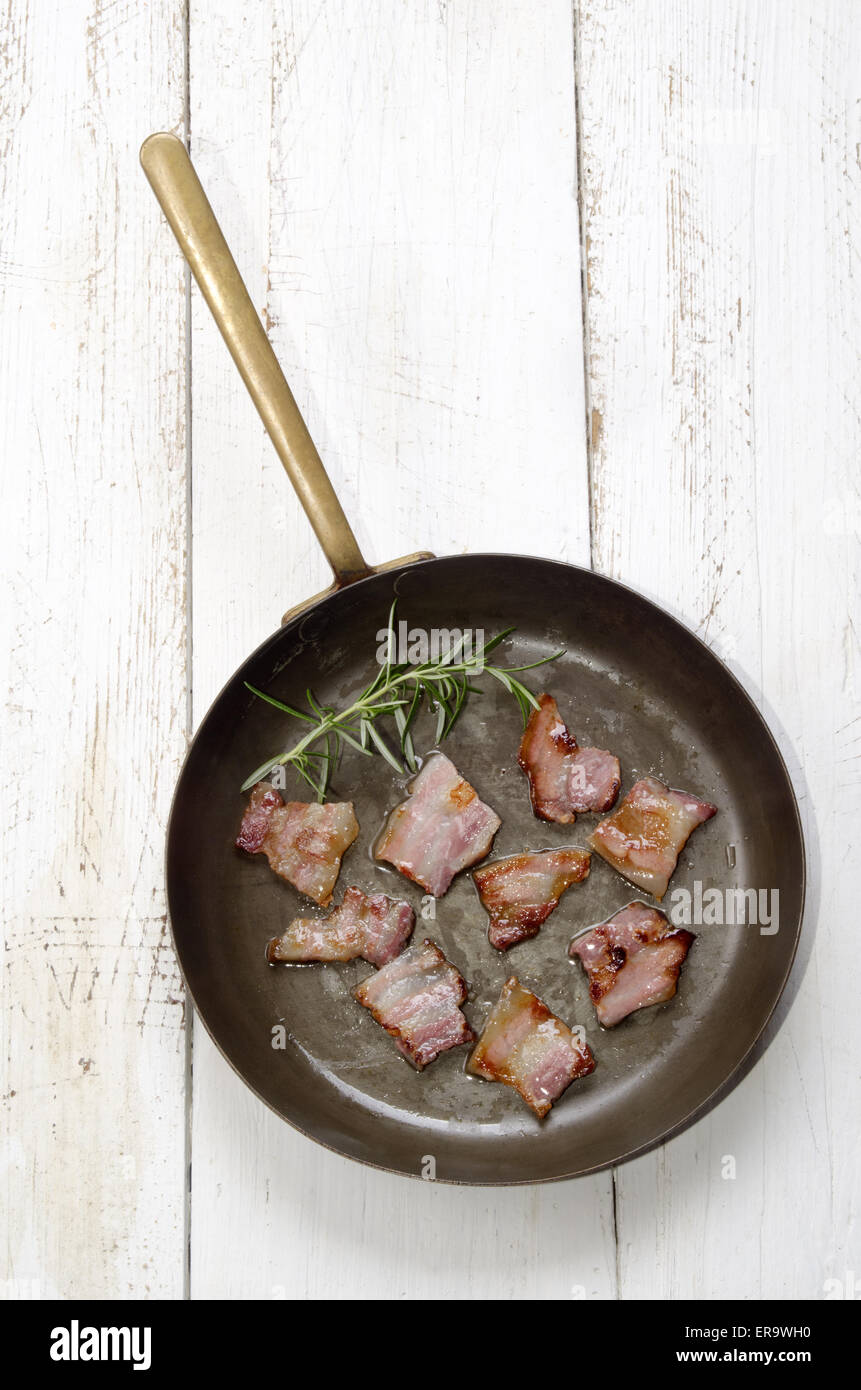 grilled bacon with oil in a rustic copper pan Stock Photo - Alamy