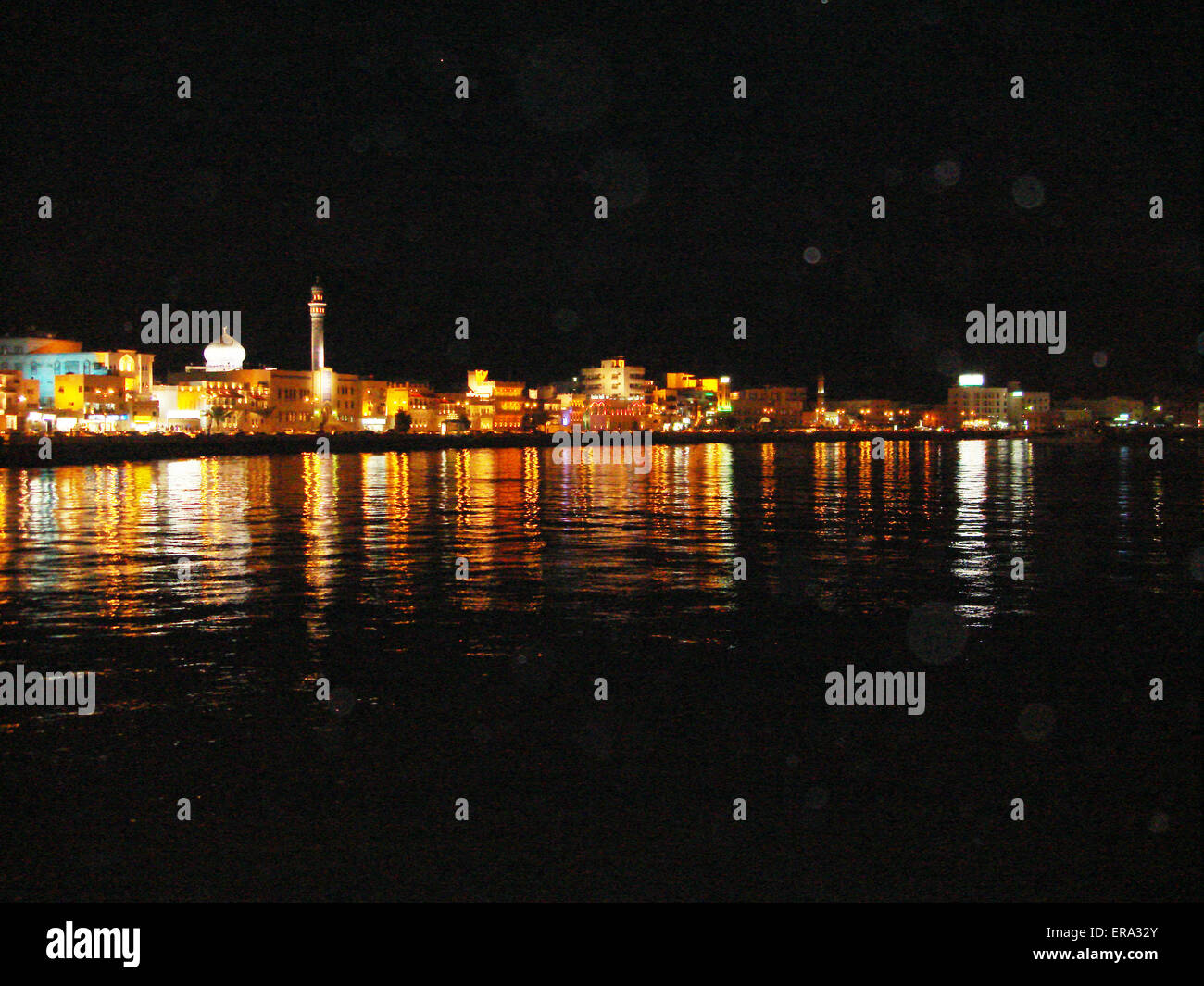 Muscat Oman at night reflected in the sea Stock Photo - Alamy