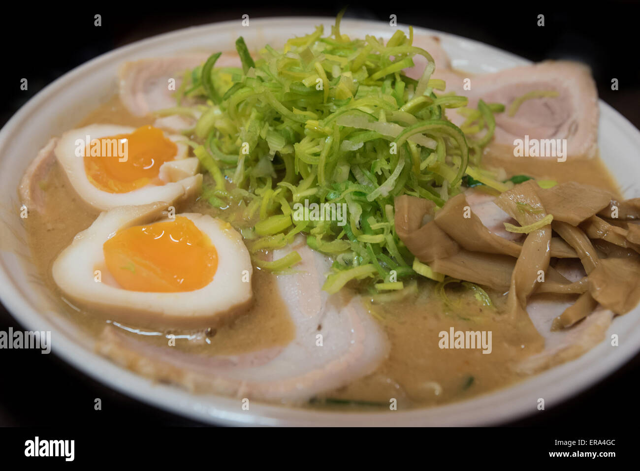 Closeup of a ramen noodle soup with porc, chives, eggs, bamboo and leek ...