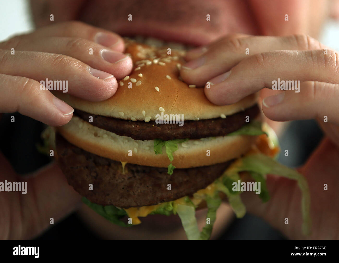 A man eats a Big Mac burger at a branch restaurant of fast food ...