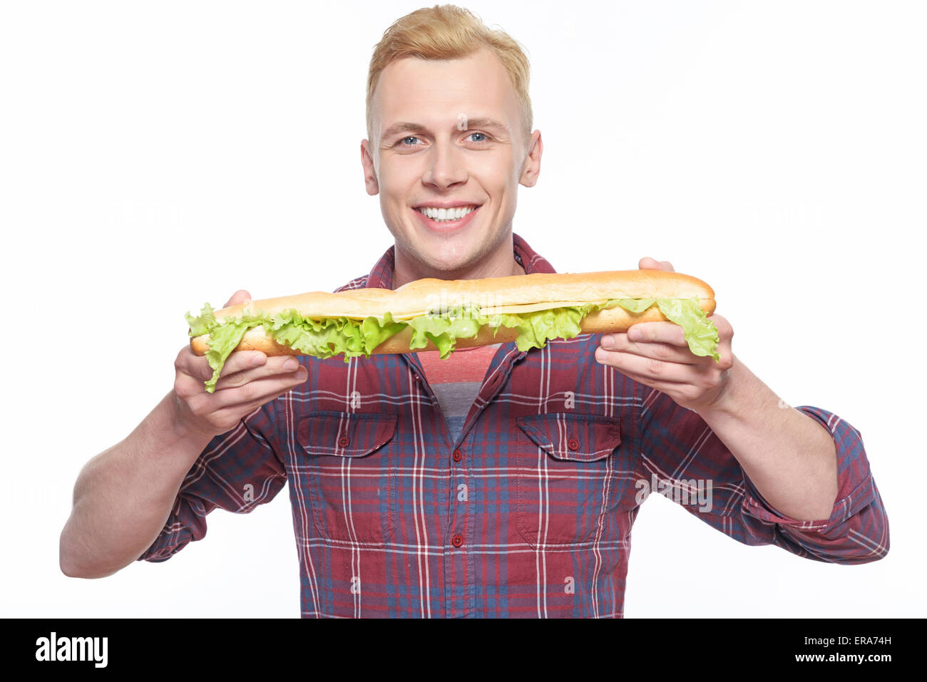 Smiling man standing with long loaf sandwich Stock Photo - Alamy