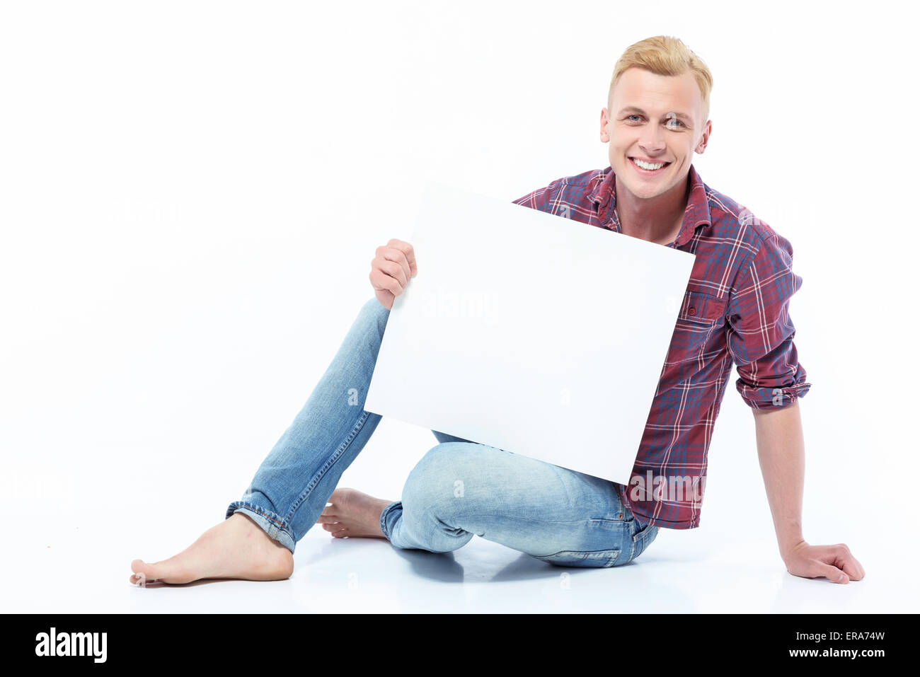 Man sitting on floor with sheet of paper Stock Photo - Alamy
