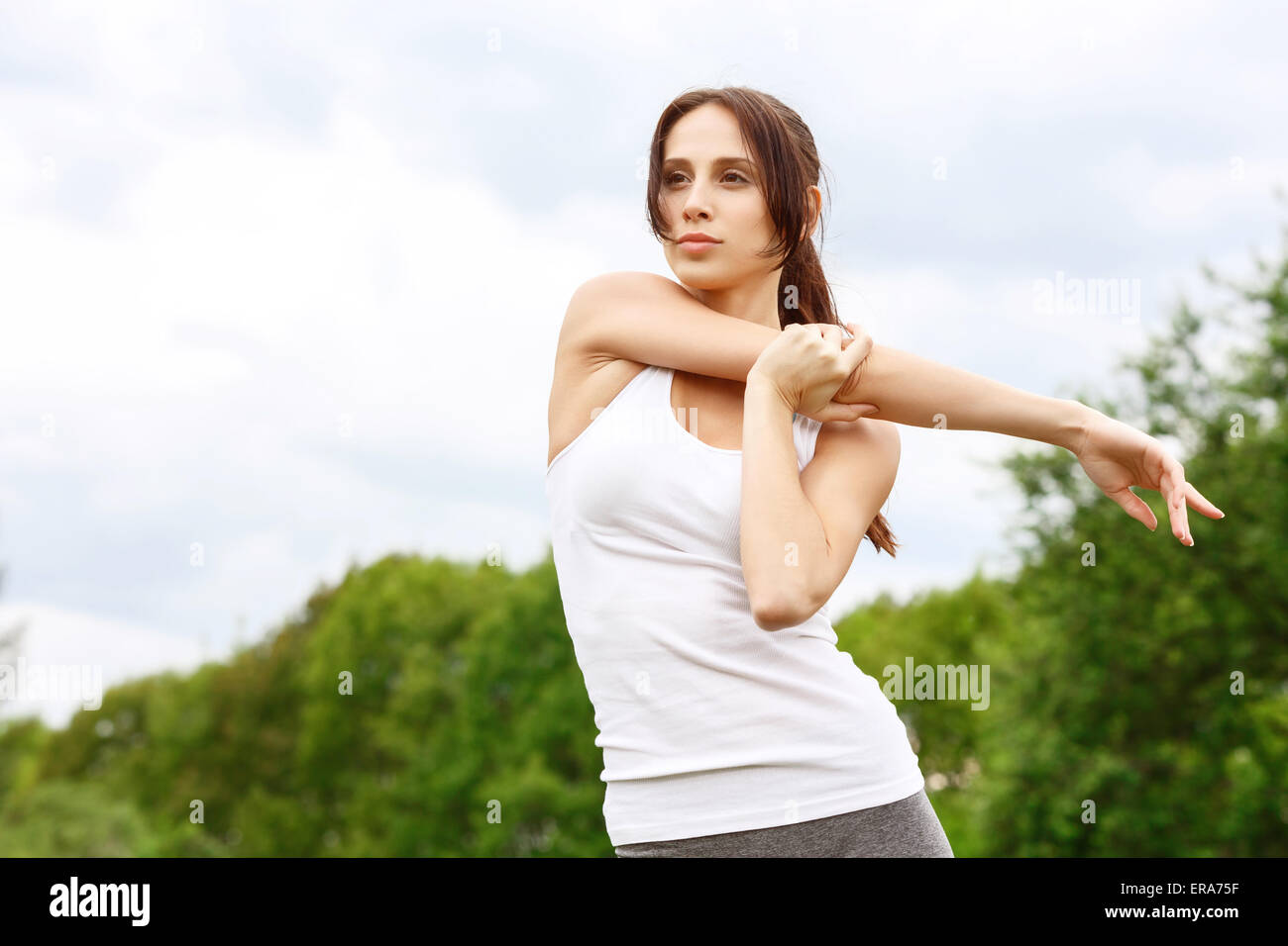 Young sportive girl stretching her arms Stock Photo - Alamy
