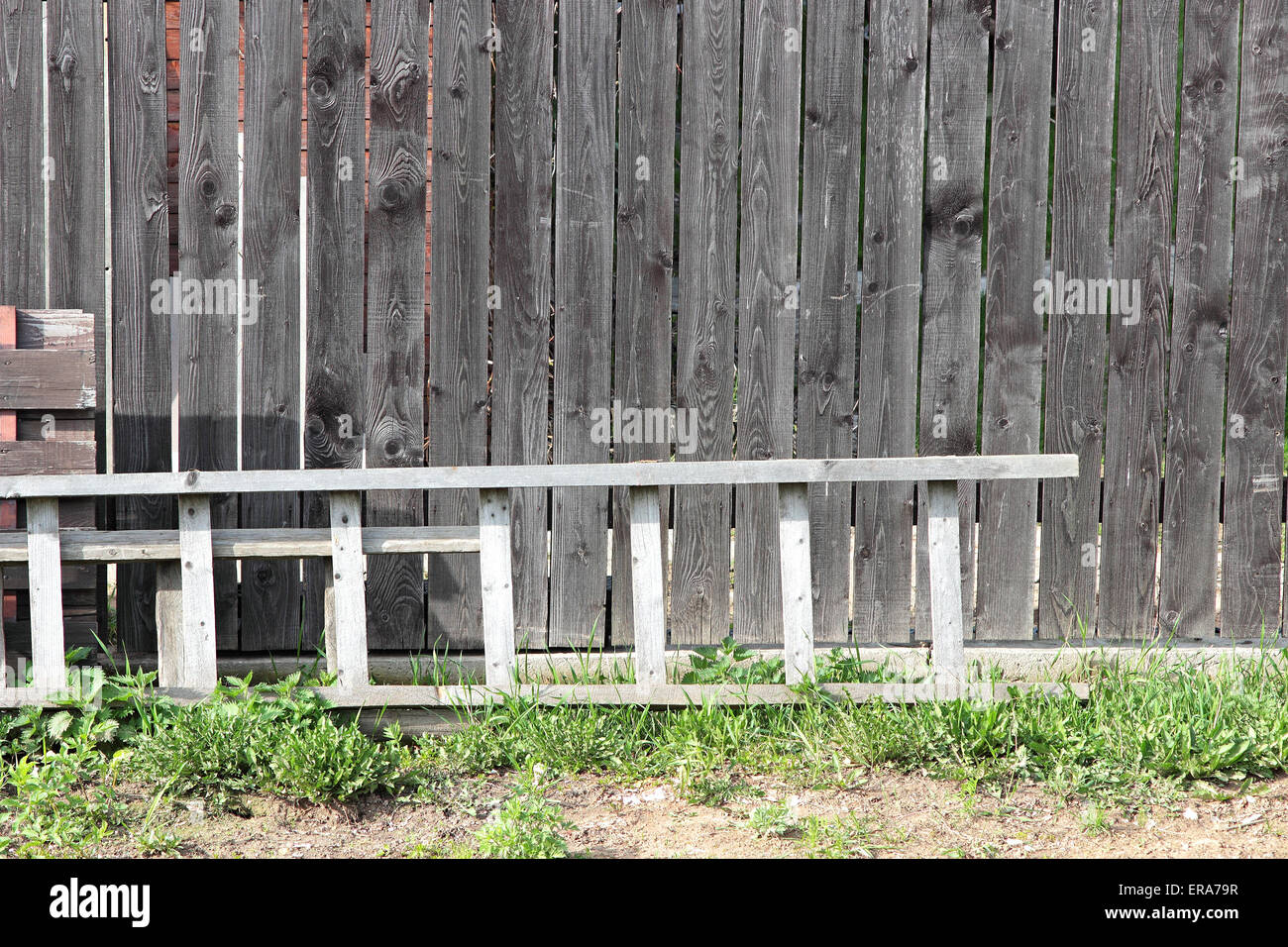 Old ladder near a wooden fence on a building site Stock Photo - Alamy