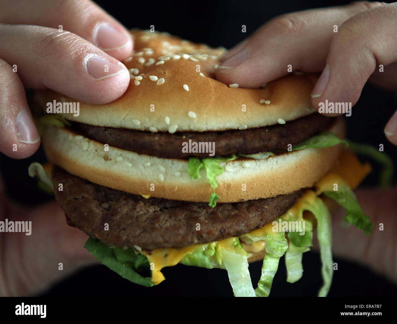 A man eats a Big Mac burger at a branch restaurant of fast food ...