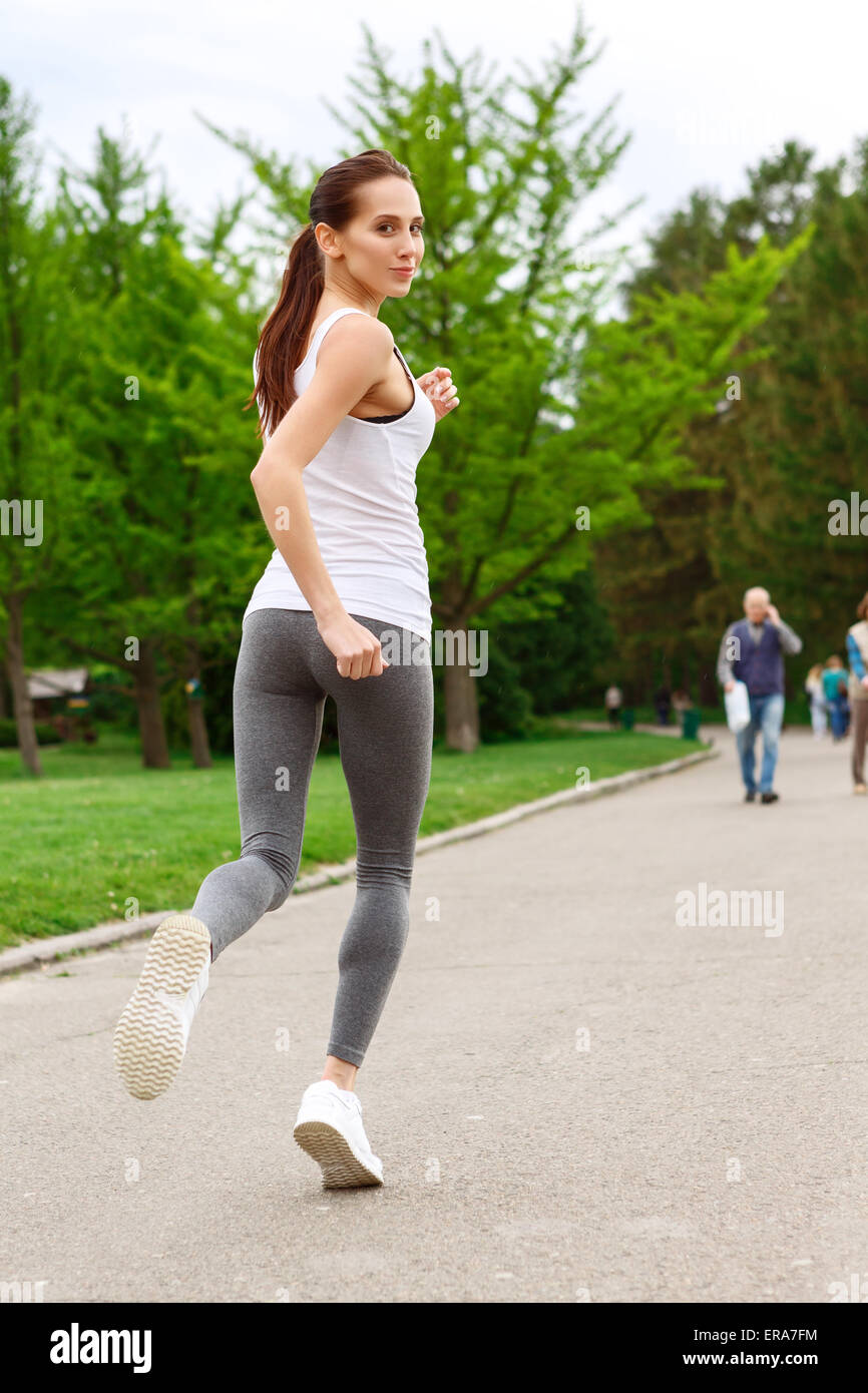 Back view of running woman in park Stock Photo - Alamy