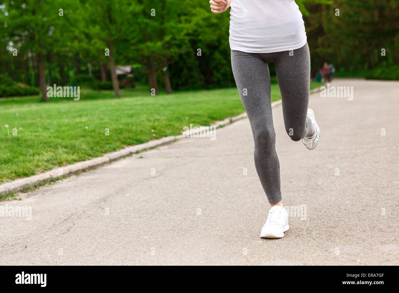 Close up of woman running in park Stock Photo - Alamy