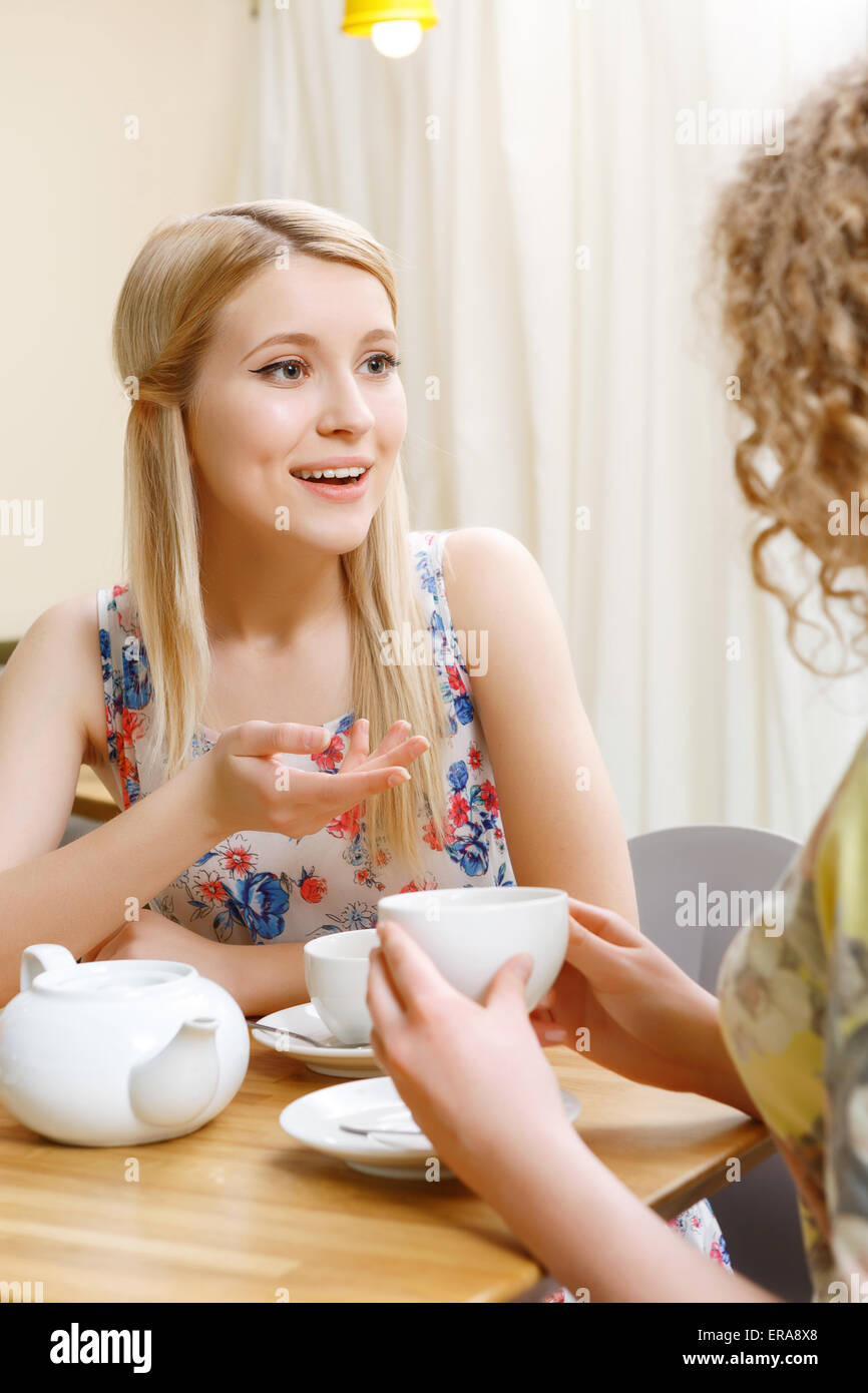 Two women having conversation in cafe Stock Photo - Alamy
