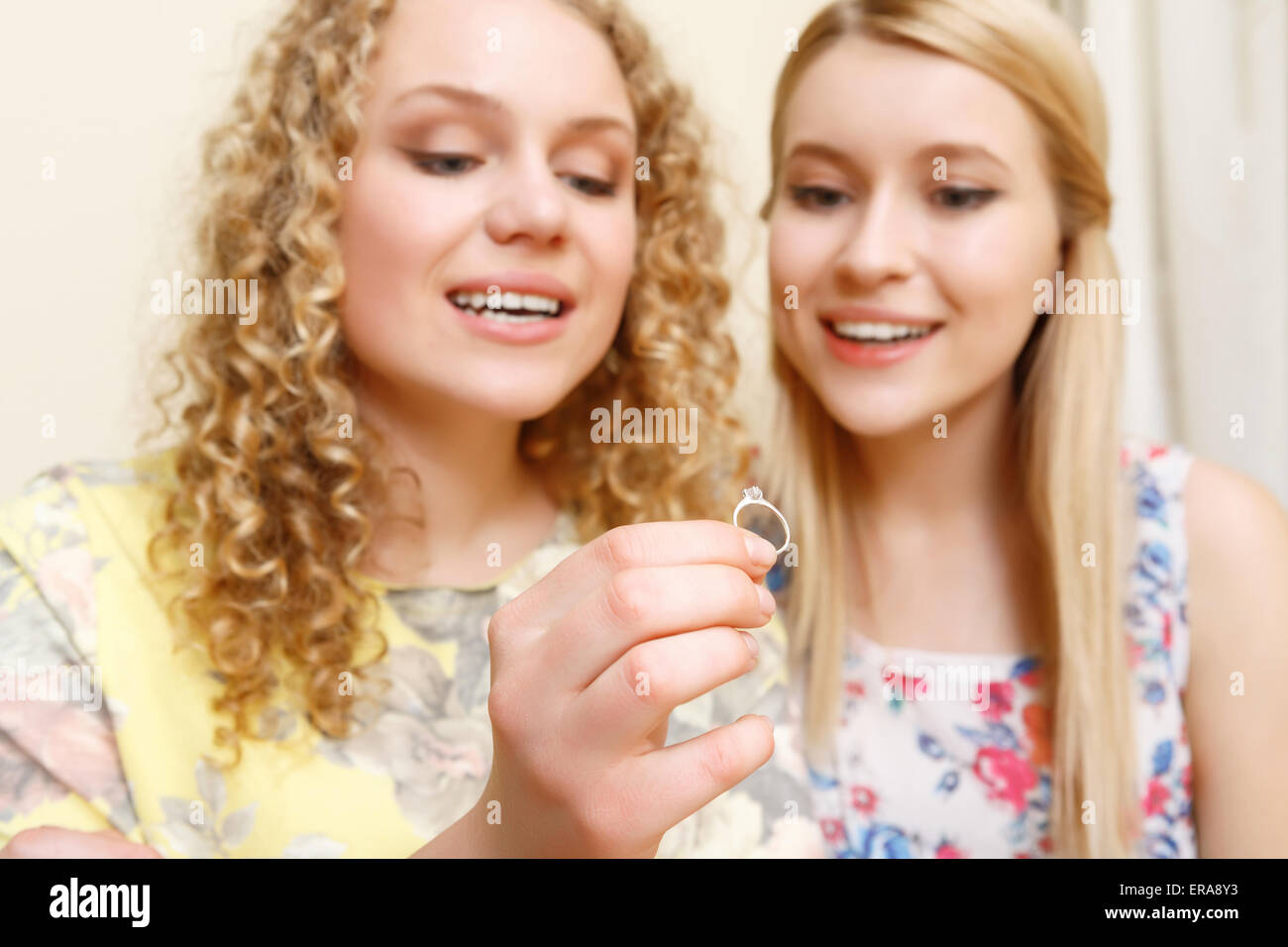 Pair of blond women looking at wedding ring Stock Photo - Alamy