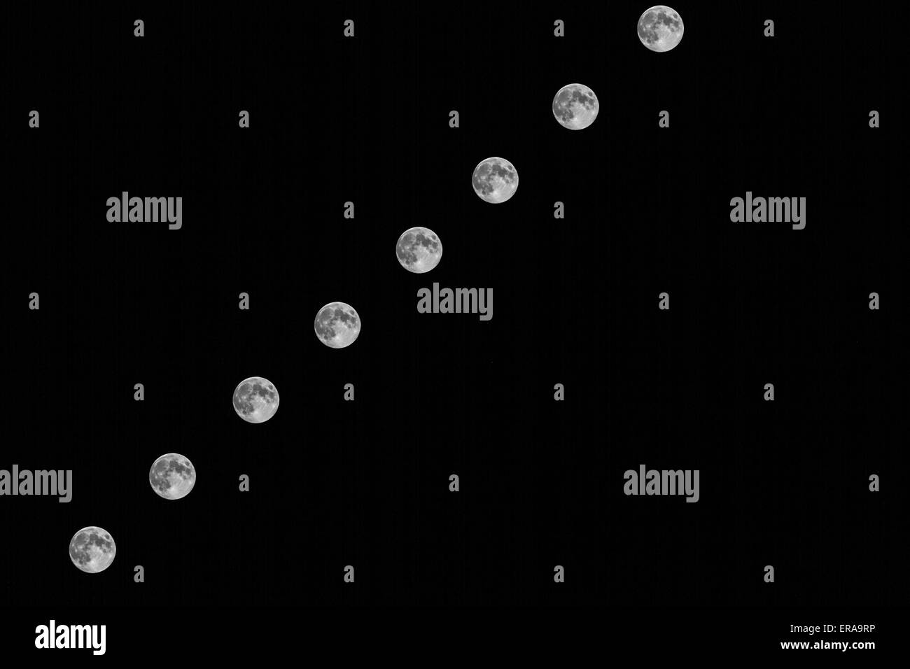 Multiple exposure of full Harvest moon Stock Photo - Alamy