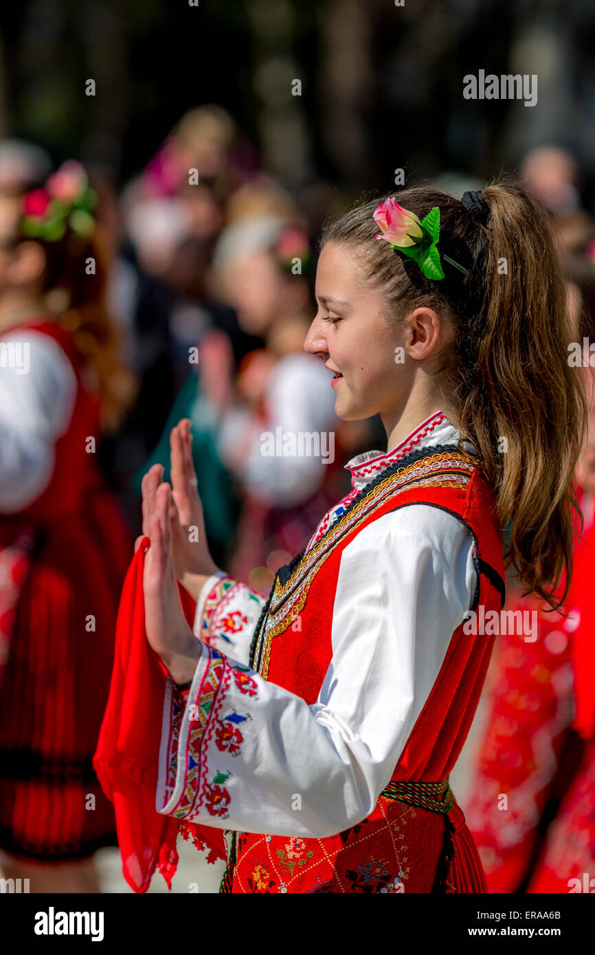 A smiling female Bulgarian folklore dancer during the traditional ...