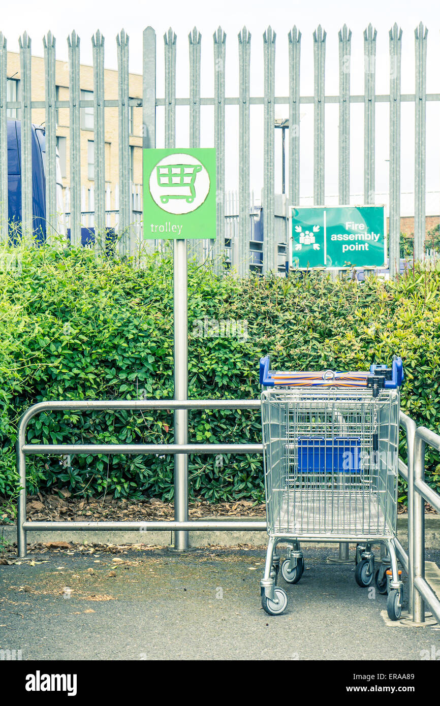Supermarket trolley in a bay parked for customers against a trolley ...