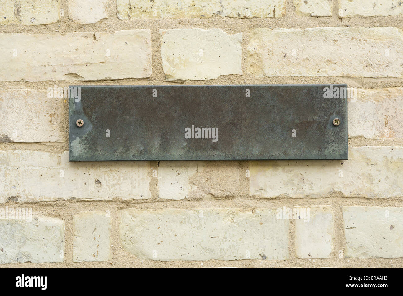 Empty stone plate mounted on brick wall closeup Stock Photo - Alamy