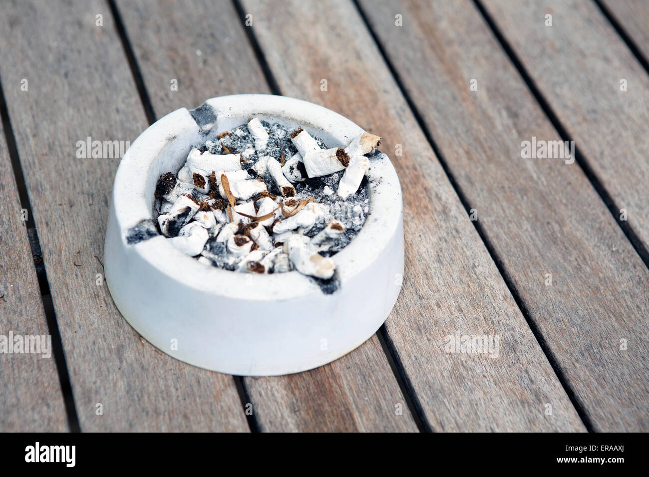 close-up of an ashtray on a wooden table Stock Photo - Alamy