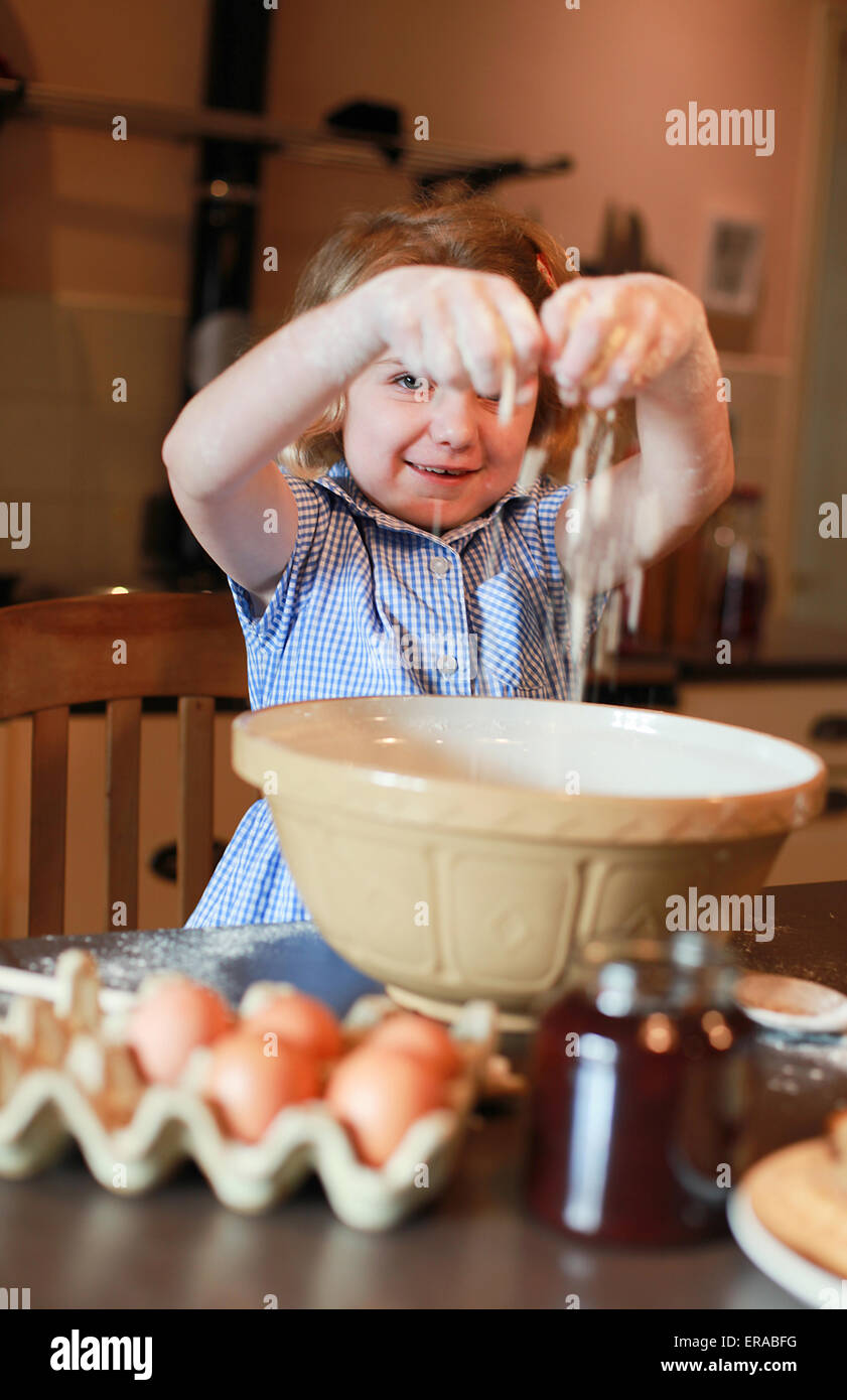 Pretty blond haired girl mixing ingredients in a bowl Stock Photo - Alamy