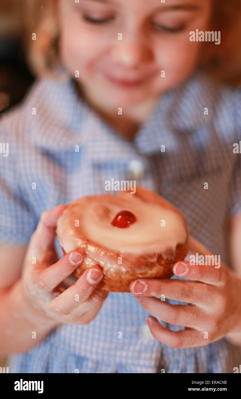 Pretty girl holding a cake, focus is on the cake Stock Photo - Alamy