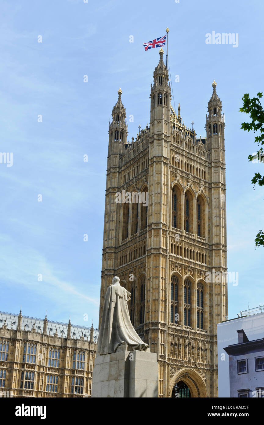 Statue of King George V and Victoria tower with the Union Jack flag at ...