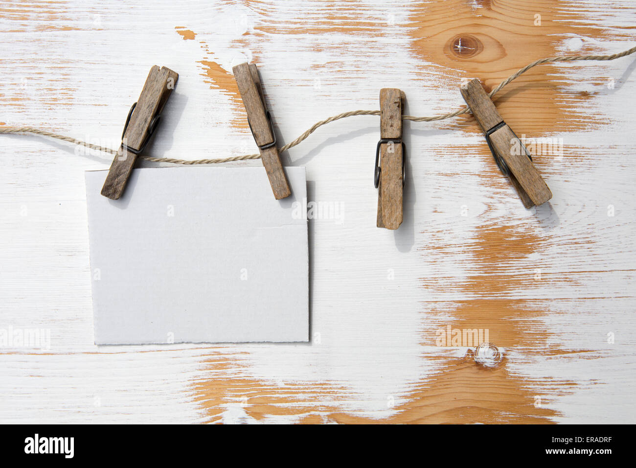white paper sign hanging on clothesline with clothespins on white ...
