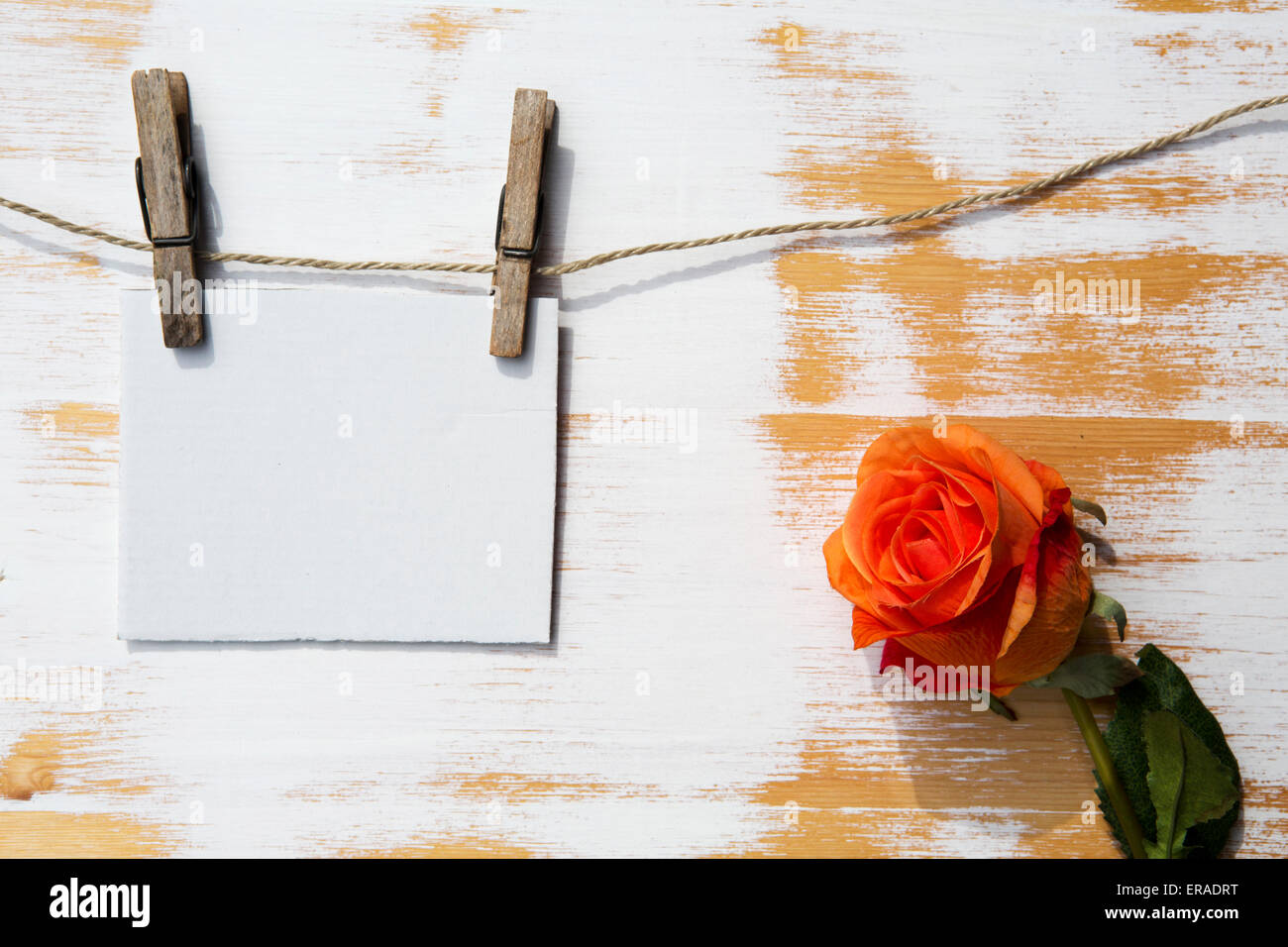 white paper sign hanging on clothesline with clothespins and an orange ...