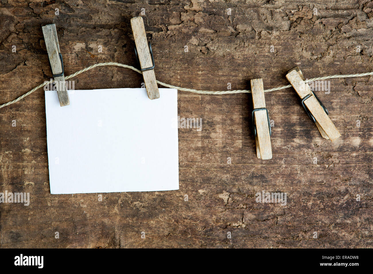 white paper sign hanging on clothesline with clothespins on rustic ...