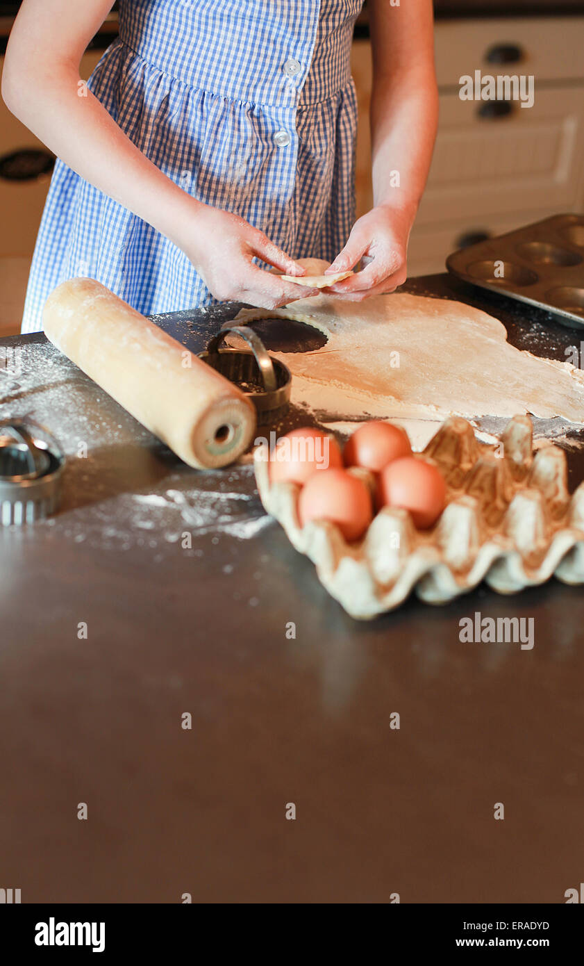 Little girl cutting out pastry for biscuits Stock Photo - Alamy