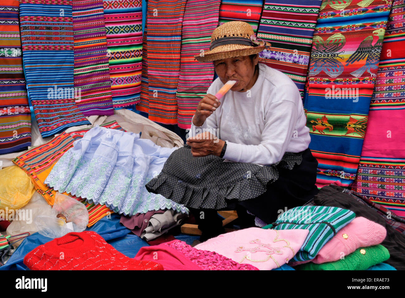 Woman selling clothing and textiles at Sunday market, Quiquijana (near ...