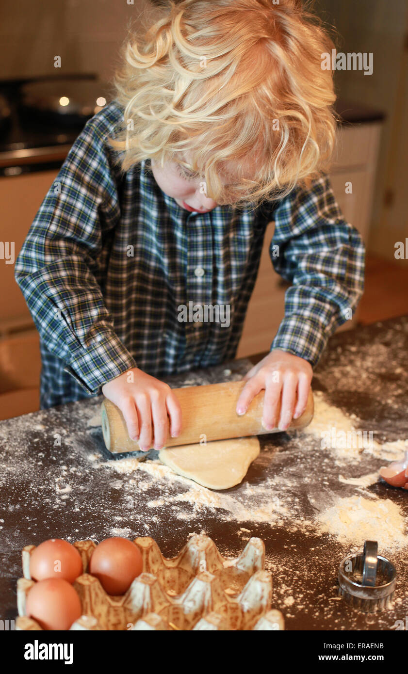 Little boy concentrating on rolling out pastry Stock Photo - Alamy
