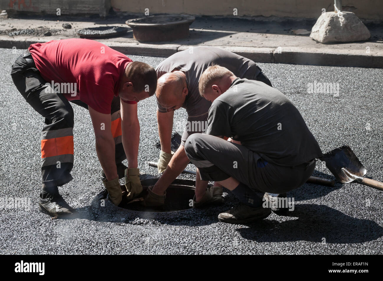 Saint-Petersburg, Russia - May 30, 2015: men at work, urban road under ...