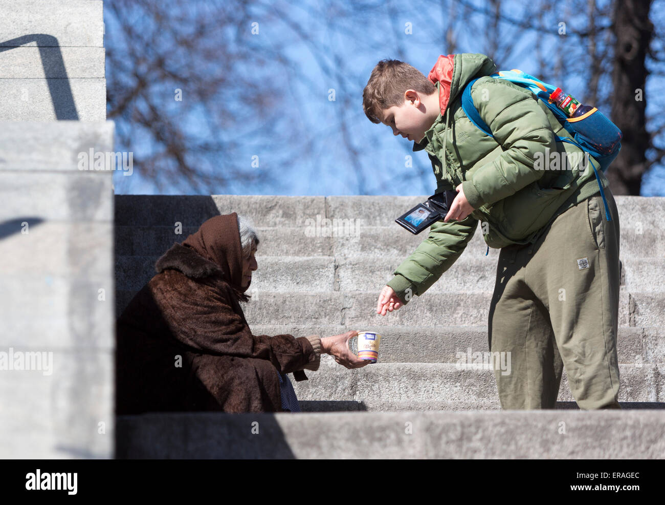 Sofia, Bulgaria - March 17, 2015: A boy is giving money to a homeless ...