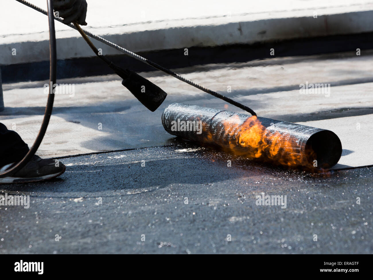 Construction workers are waterproofing a bridge surface floor at a ...