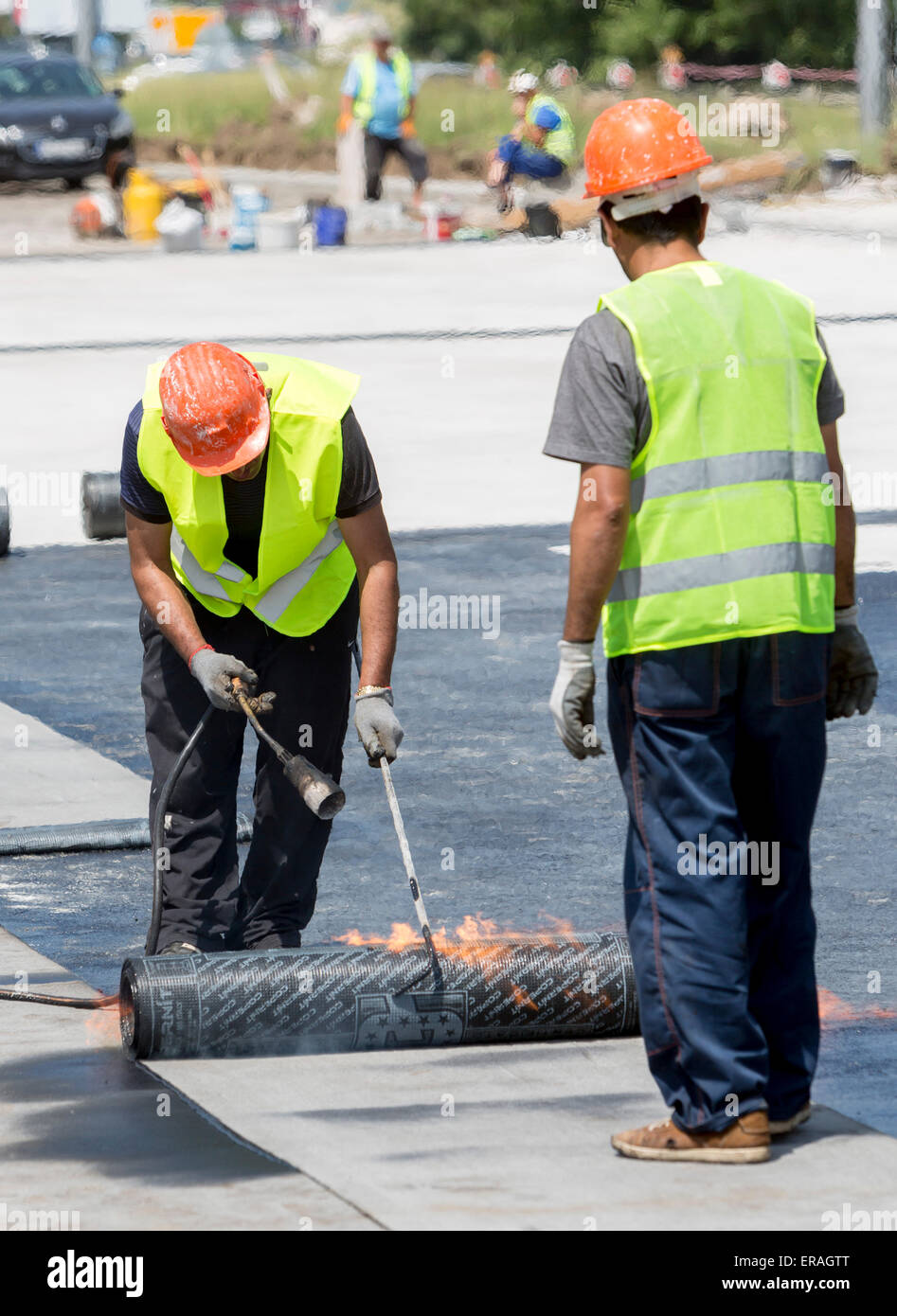 Sofia, Bulgaria - May 21, 2015: Construction workers are waterproofing ...