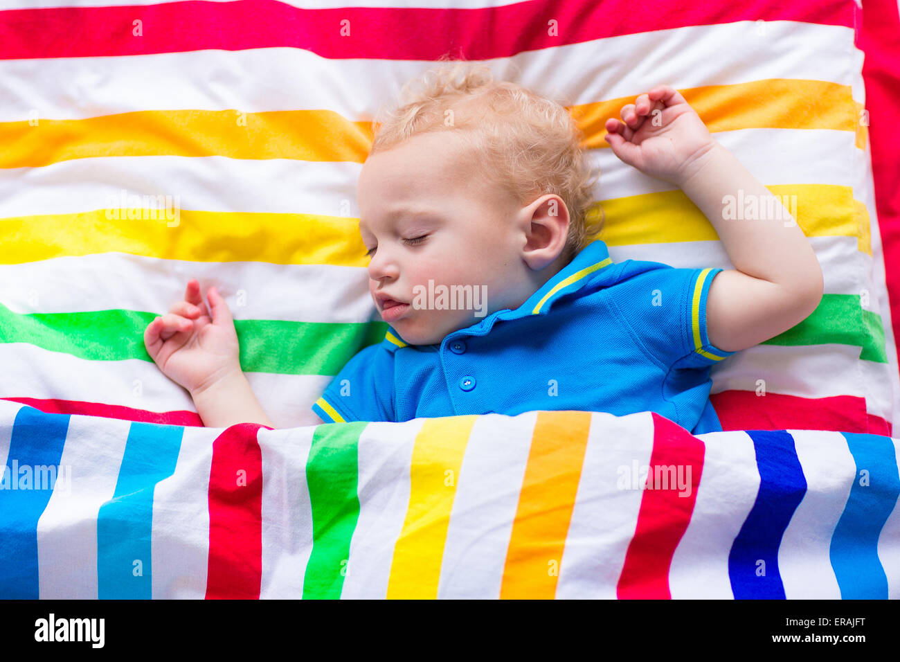 Child sleeping in colorful bed. Little baby boy asleep. Kids textile in ...
