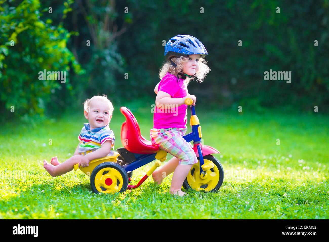 Children riding a bike. Kids enjoying a bicycle ride. Little ...