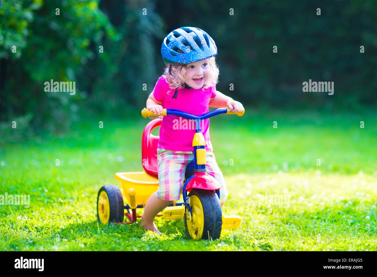 Children riding a bike. Kids enjoying a bicycle ride. Little ...