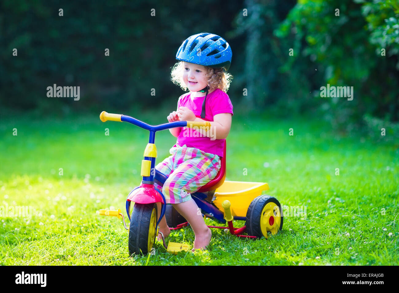 Children riding a bike. Kids enjoying a bicycle ride. Little ...