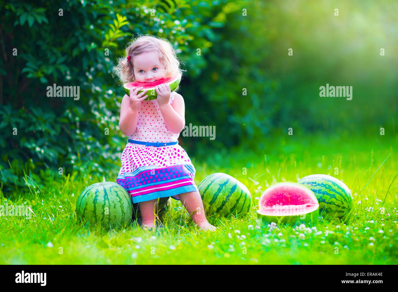 Child eating watermelon in the garden. Kids eat fruit outdoors. Healthy ...