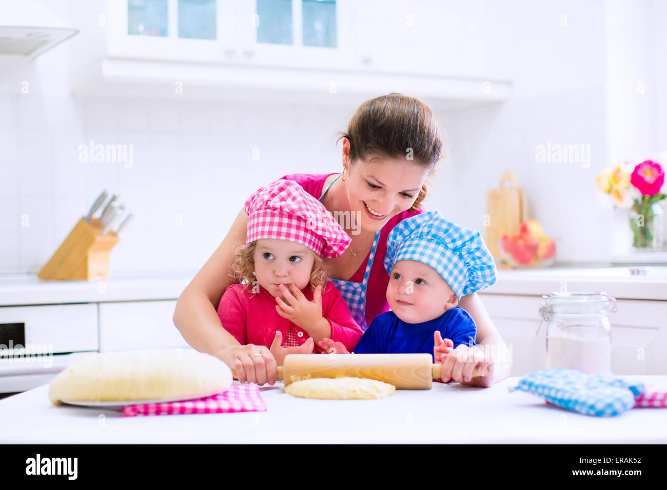 Kids and mother baking. Two children and parent cooking. Little girl ...