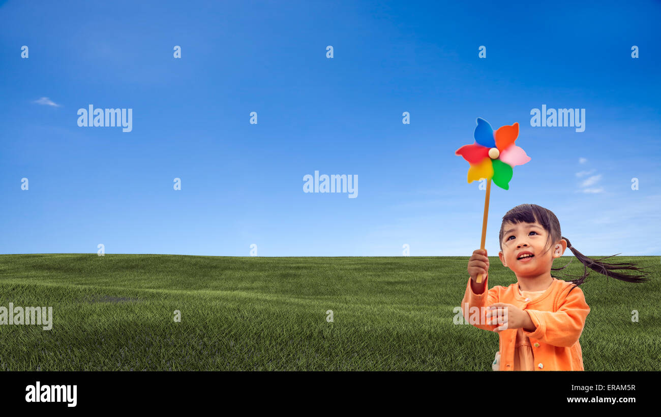 Closeup of little girl blowing wind wheel for adv or others purpose use ...