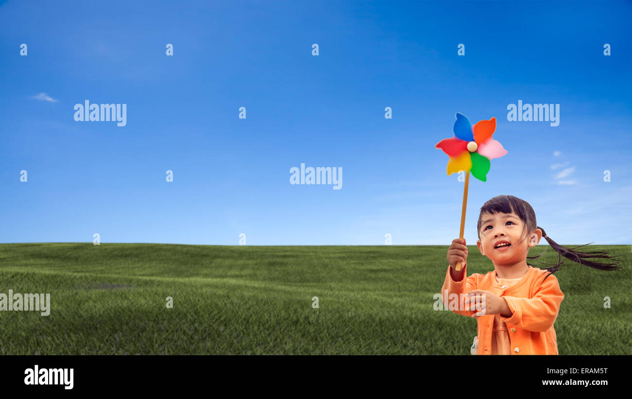 Closeup of little girl blowing wind wheel for adv or others purpose use ...