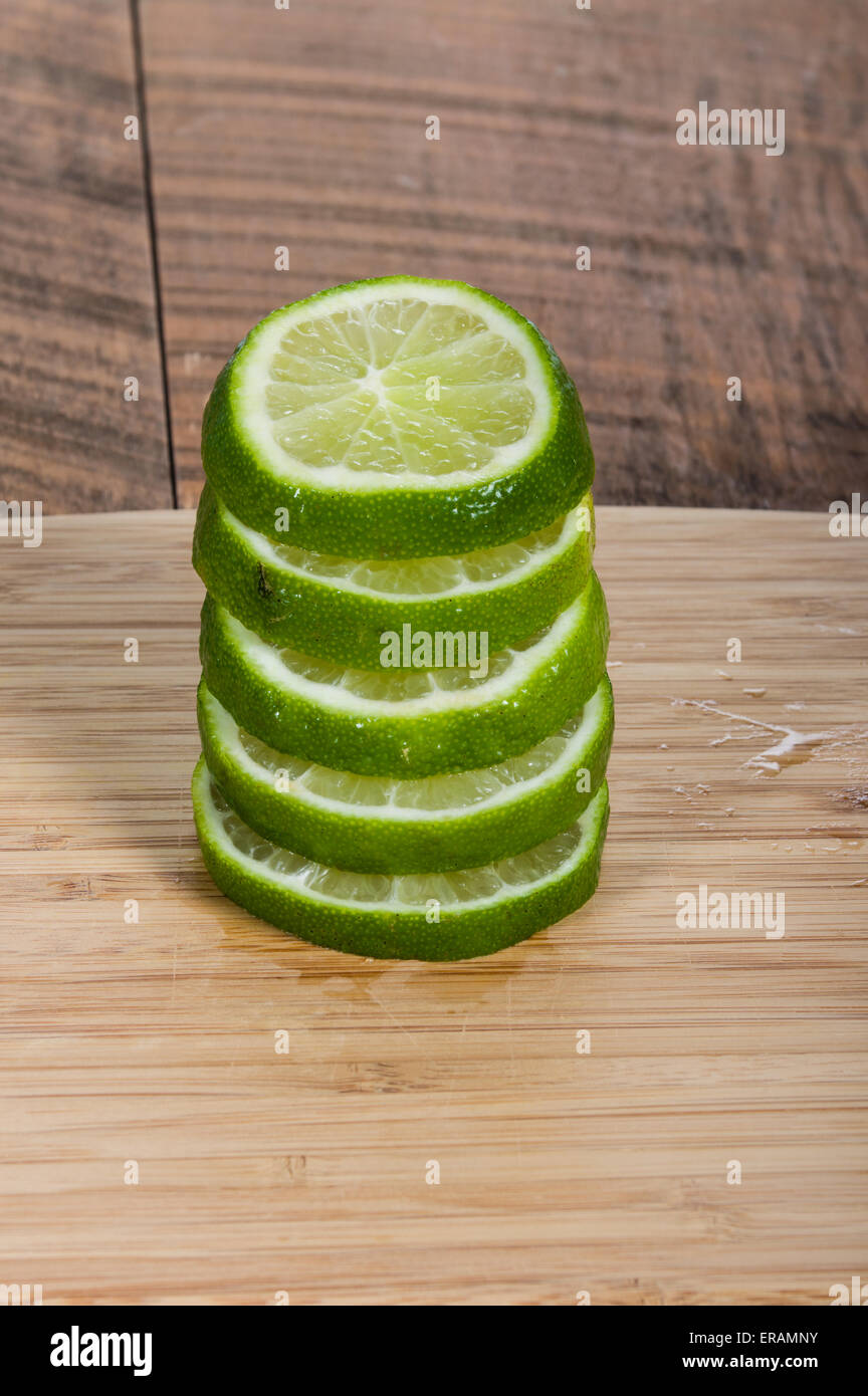 Stack of lime slices on a cutting board Stock Photo - Alamy