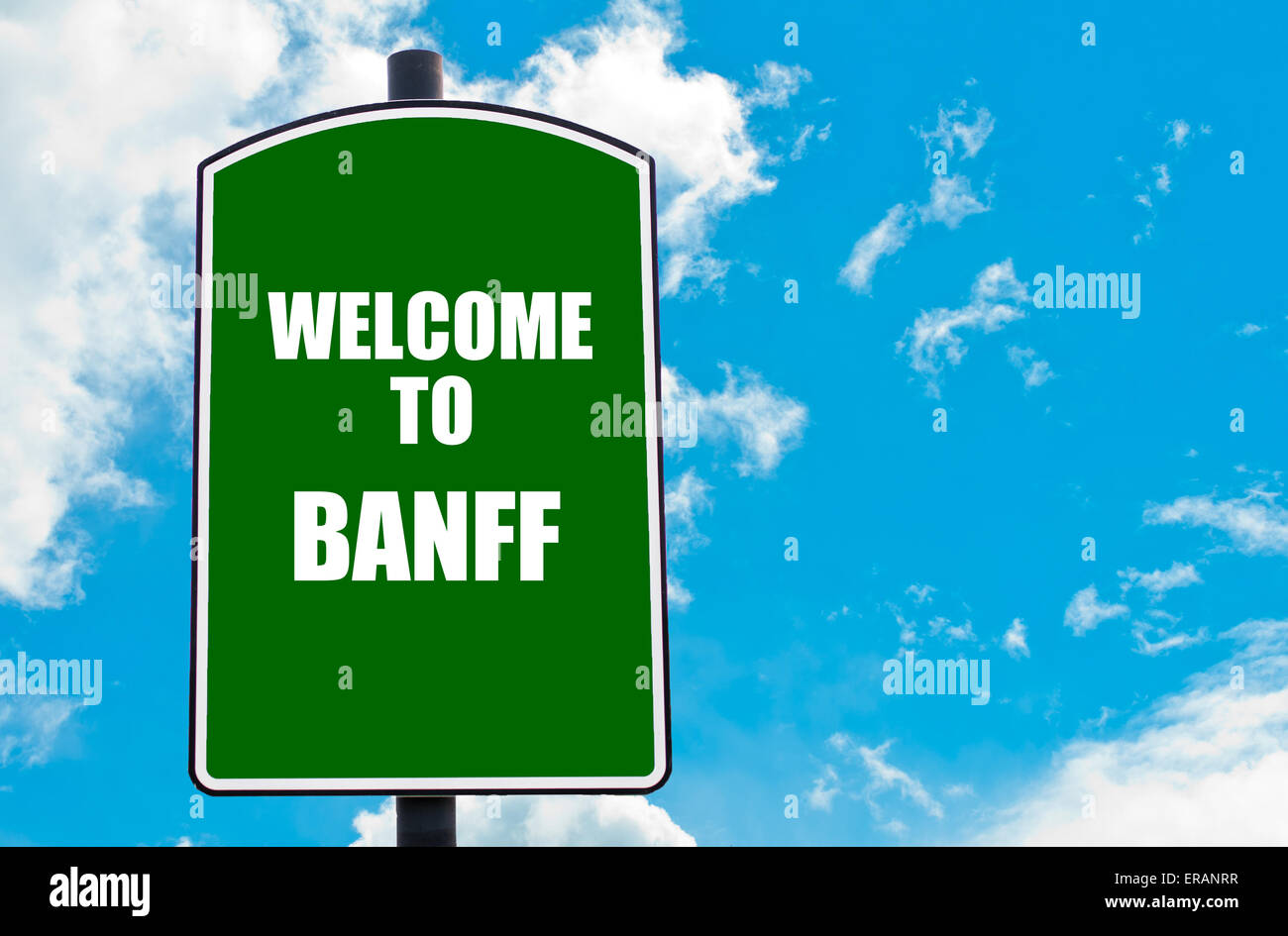 Green road sign with greeting message WELCOME TO BANFF isolated over ...