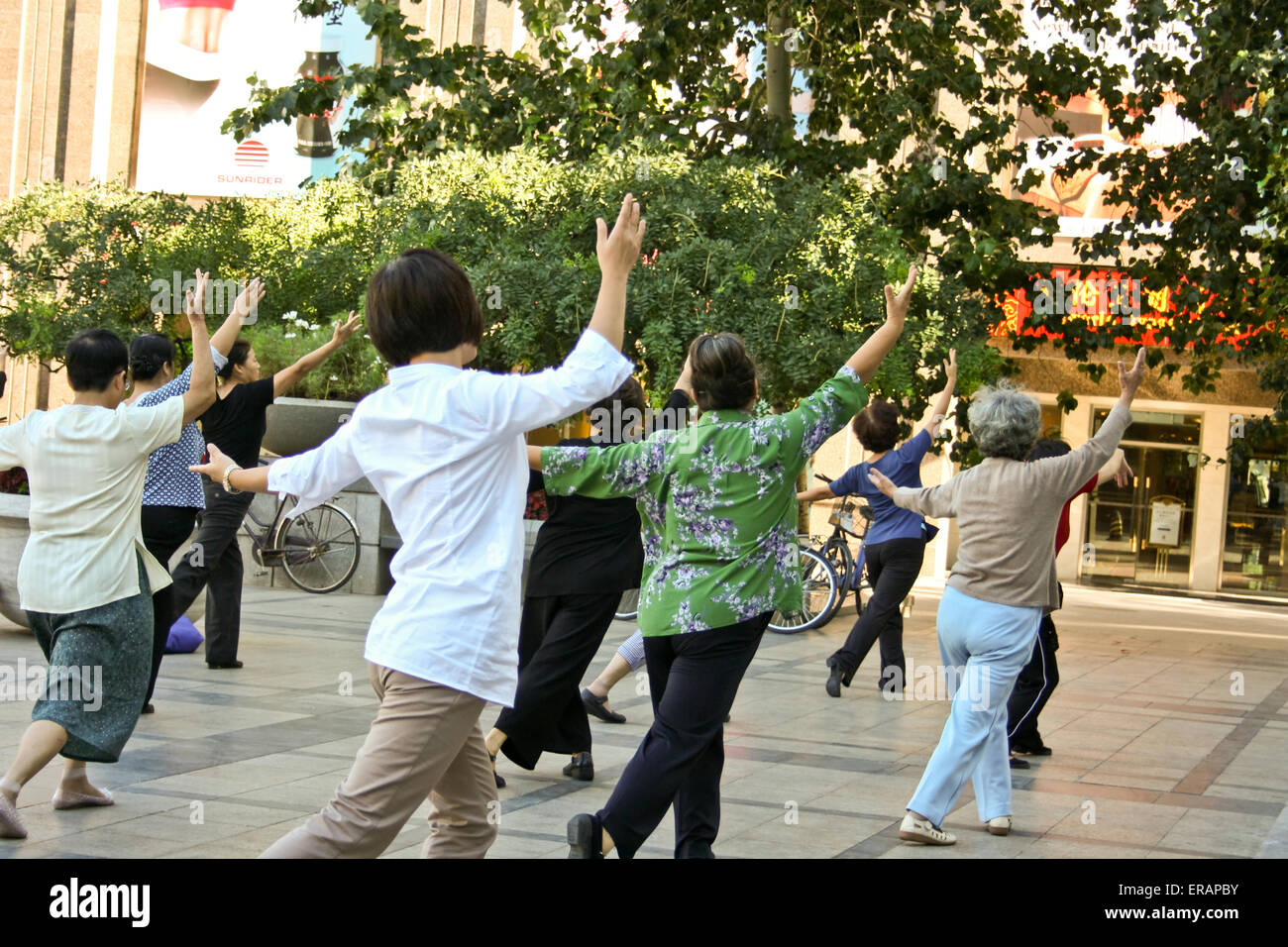 City Beijing. Public square. Morning gymnastics. Women dancing a ...