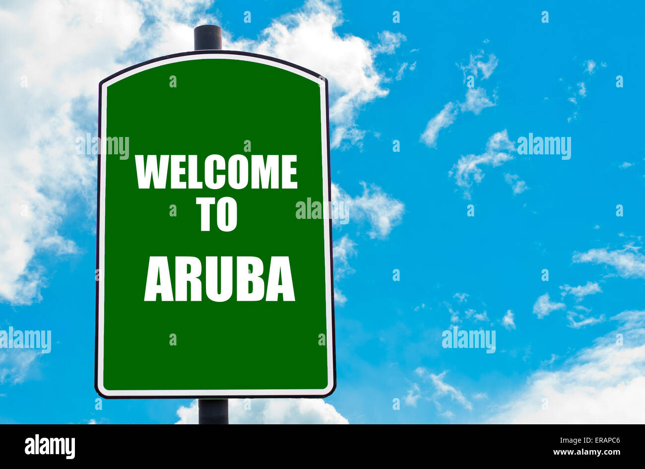 Green road sign with greeting message WELCOME TO ARUBA isolated over ...