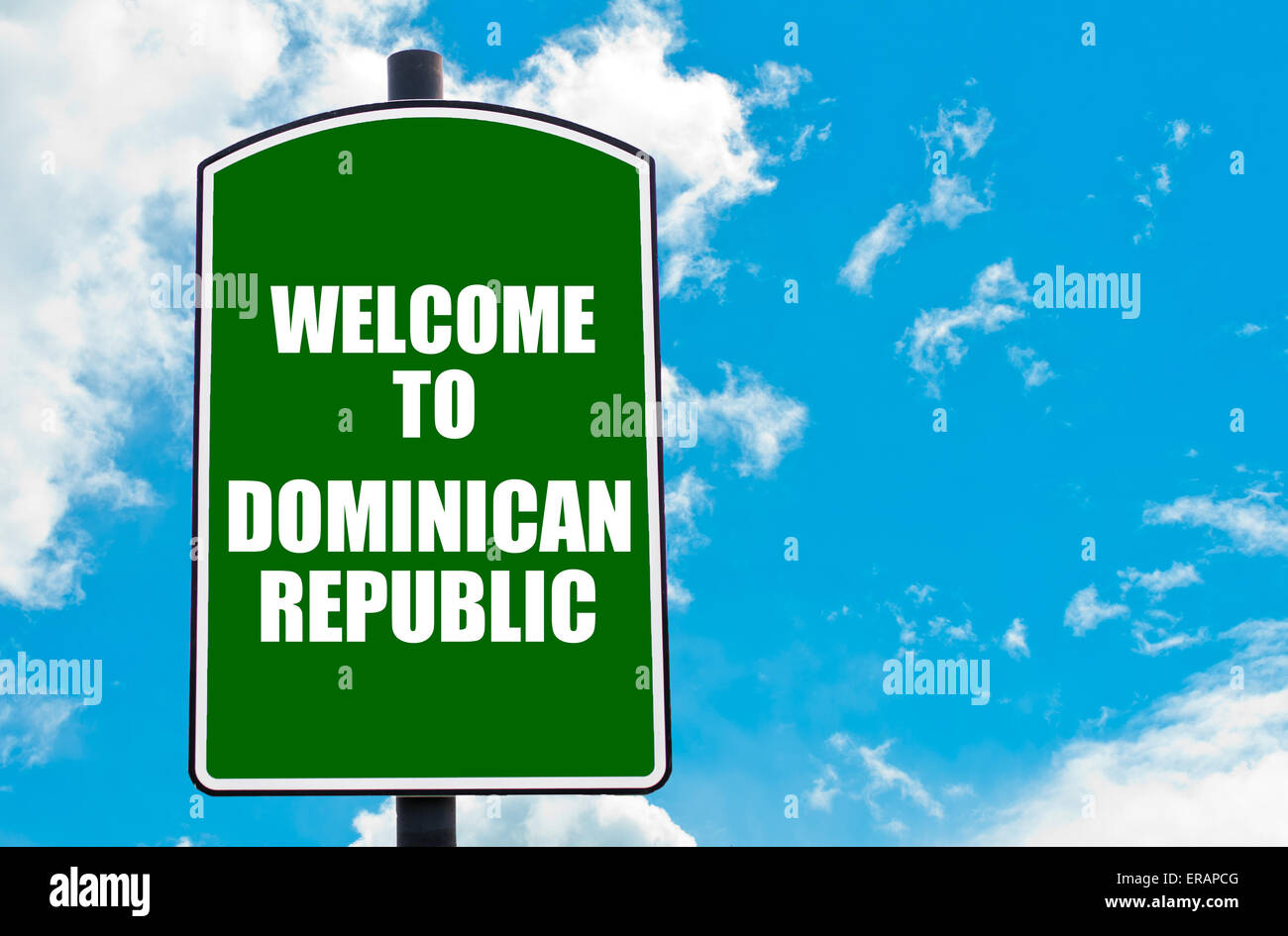 Green road sign with greeting message WELCOME TO DOMINICAN REPUBLIC ...