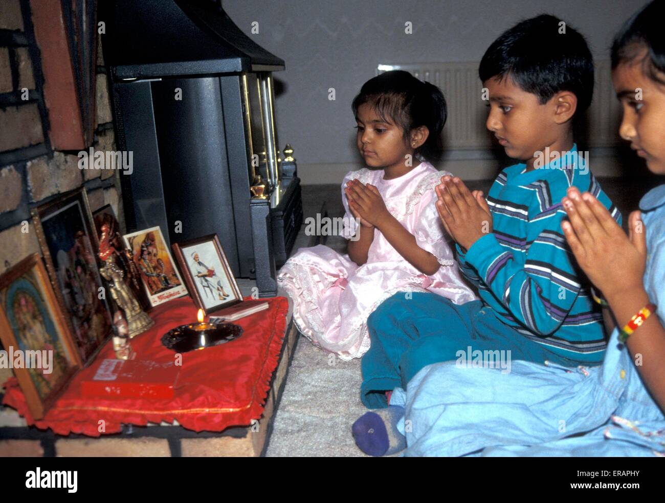 Hindu children in south London offer prayers before a small family ...