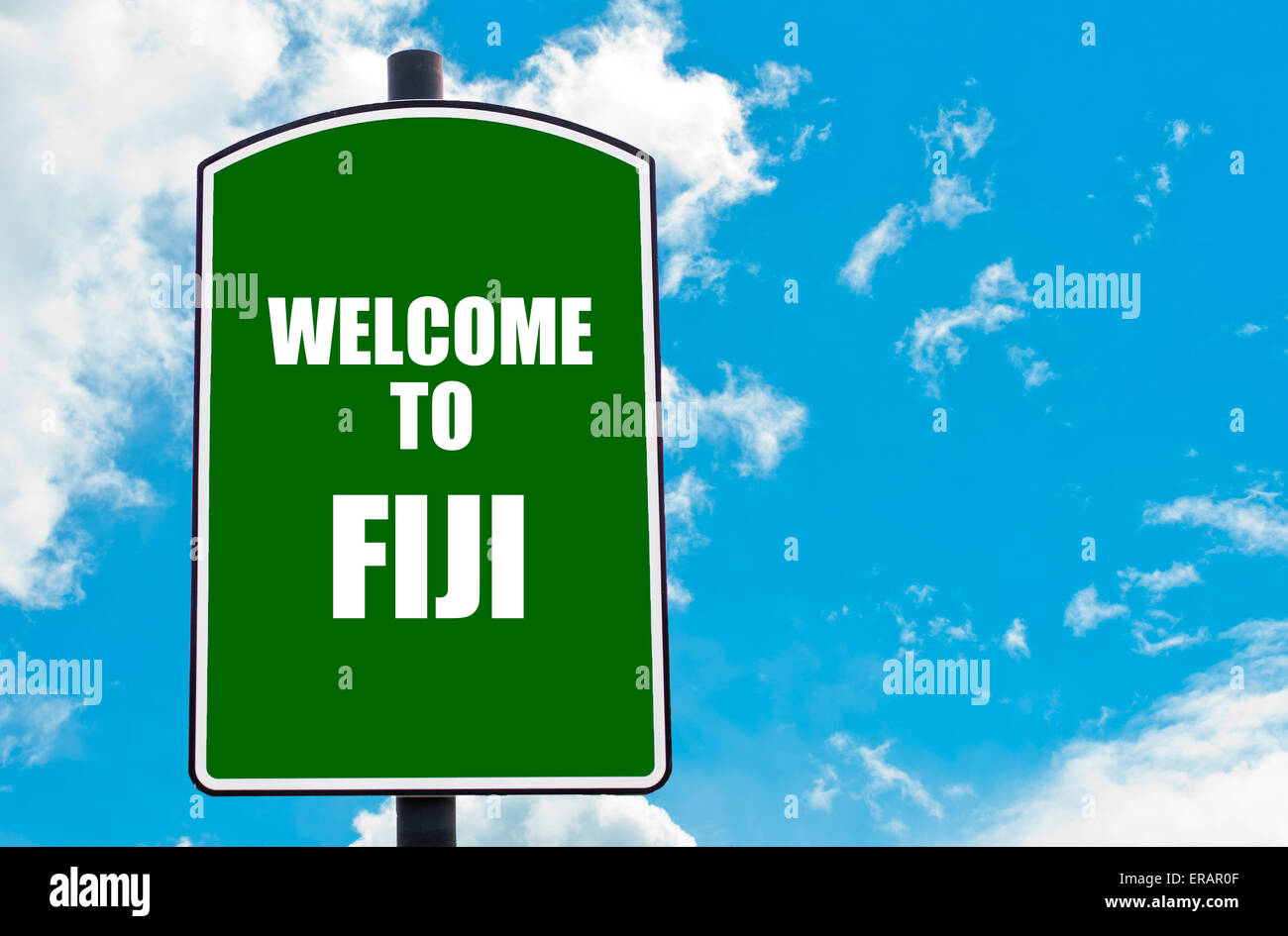 Green road sign with greeting message WELCOME TO FIJI isolated over ...