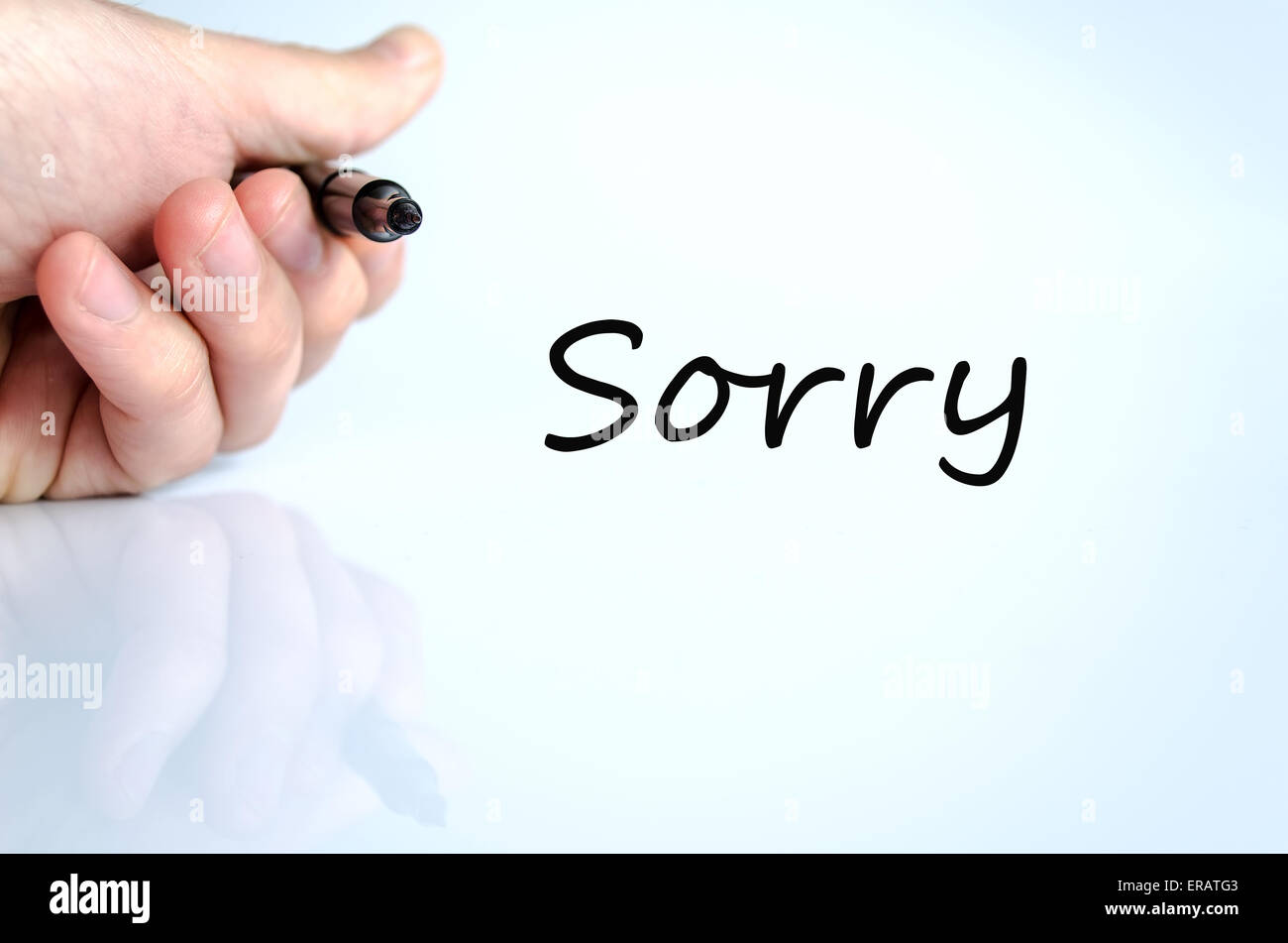 Pen in the hand isolated over white background Sorry Concept Stock ...