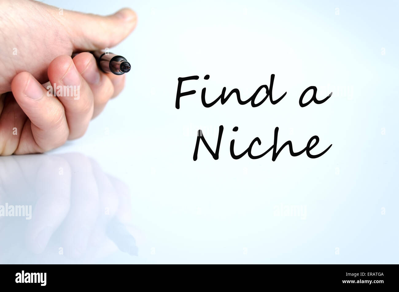 Pen in the hand isolated over white background Find a Niche Concept ...